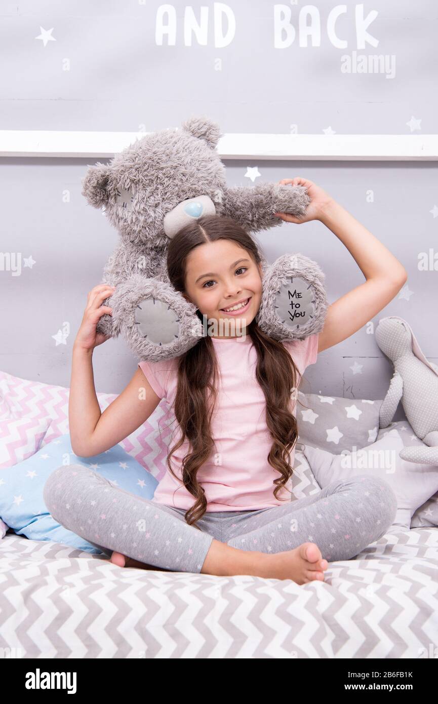 Playing together. Happy child play with teddy bear. Little kid enjoy ...