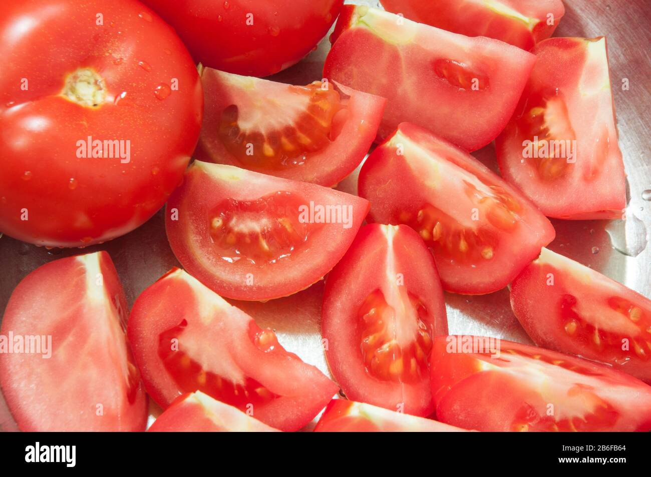 Food background. Tomatos on the chopping block Stock Photo - Alamy