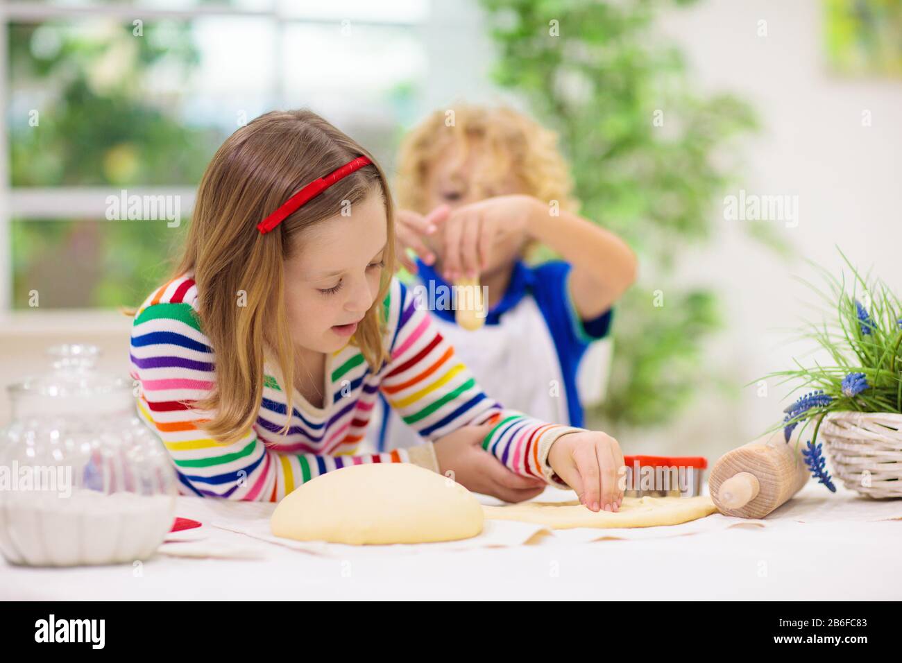 Kids baking pie in white sunny kitchen. Children cooking dinner. Boy ...