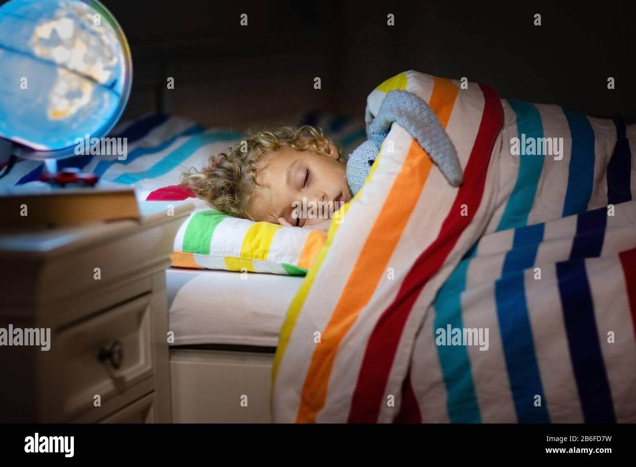 Child sleeping at night. Kids sleep. Little boy relaxing in bed with ...