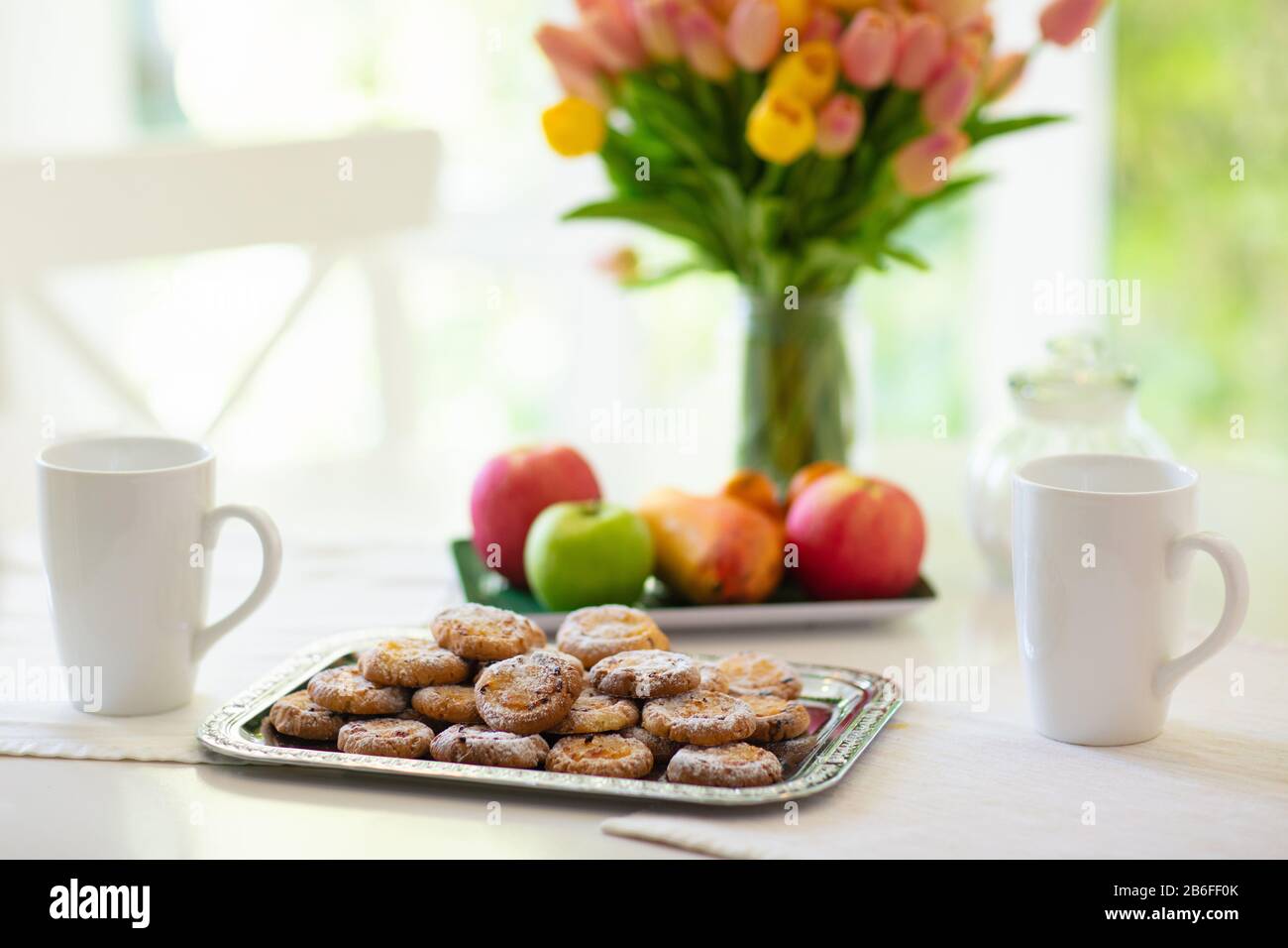 Homemade cookies on breakfast table in white sunny dining room or ...
