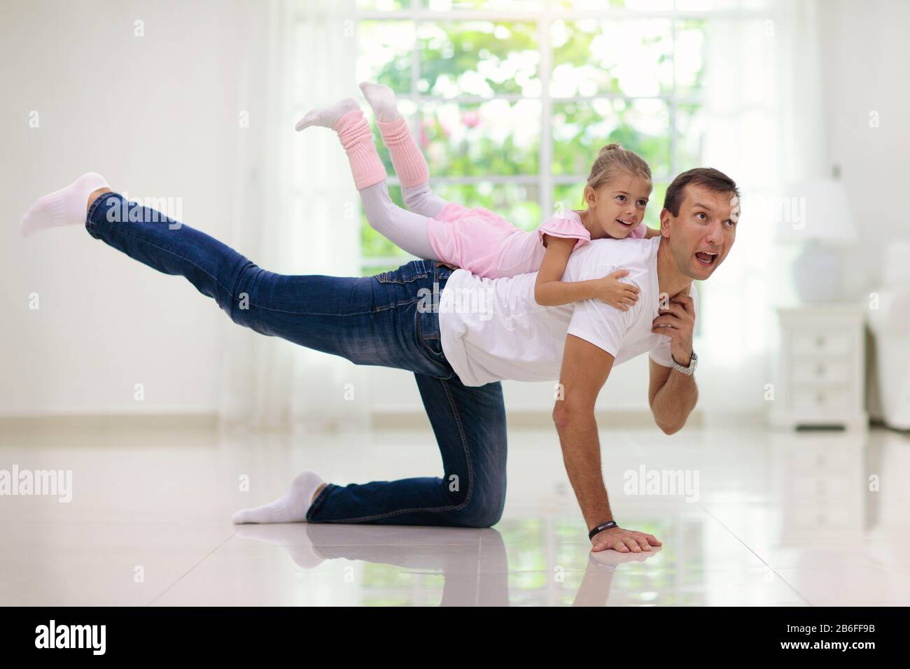 Father and daughter in baby ballet studio. Dad playing with little ...