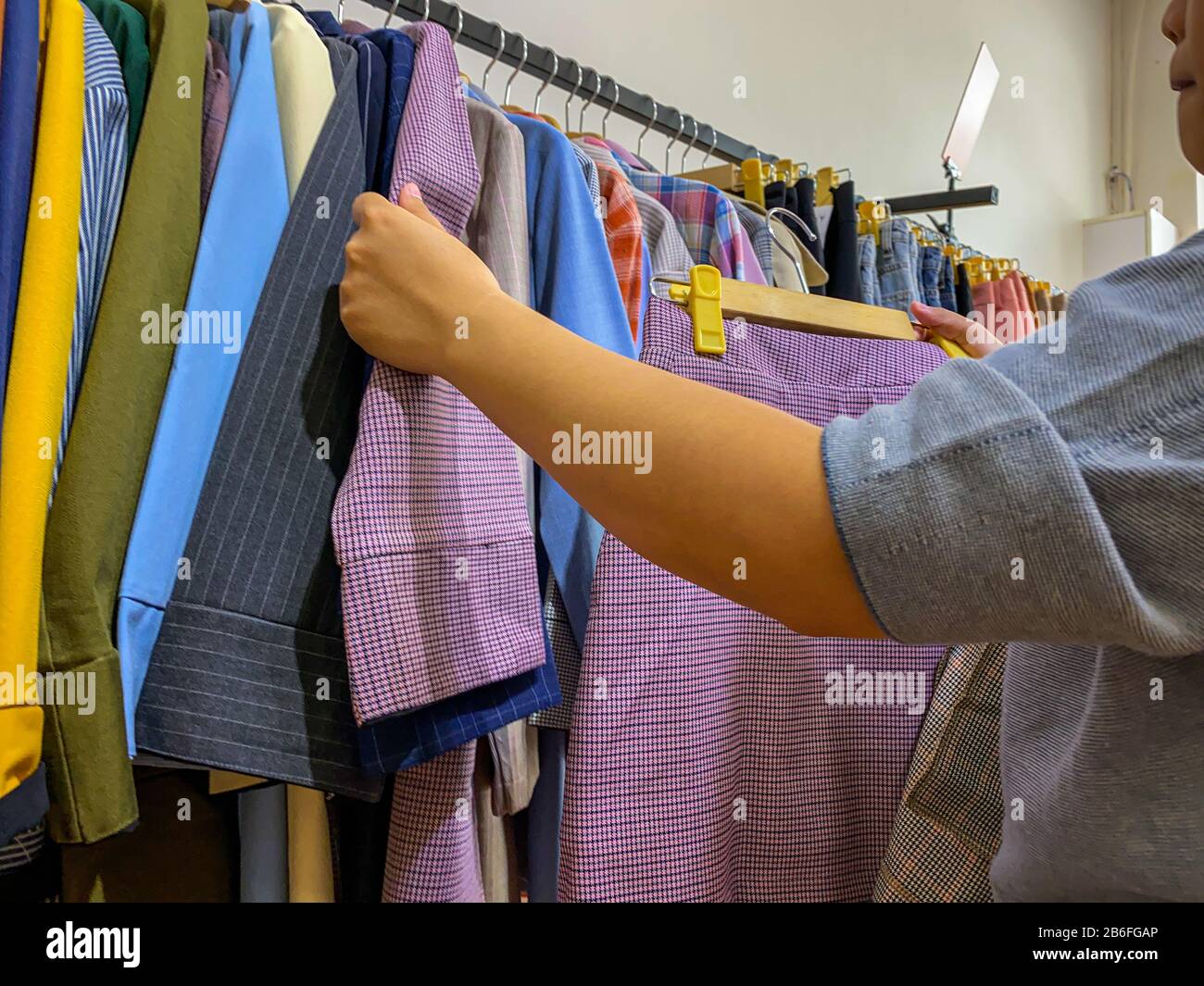 Woman hands choosing outfit while shopping at retail store Stock Photo ...
