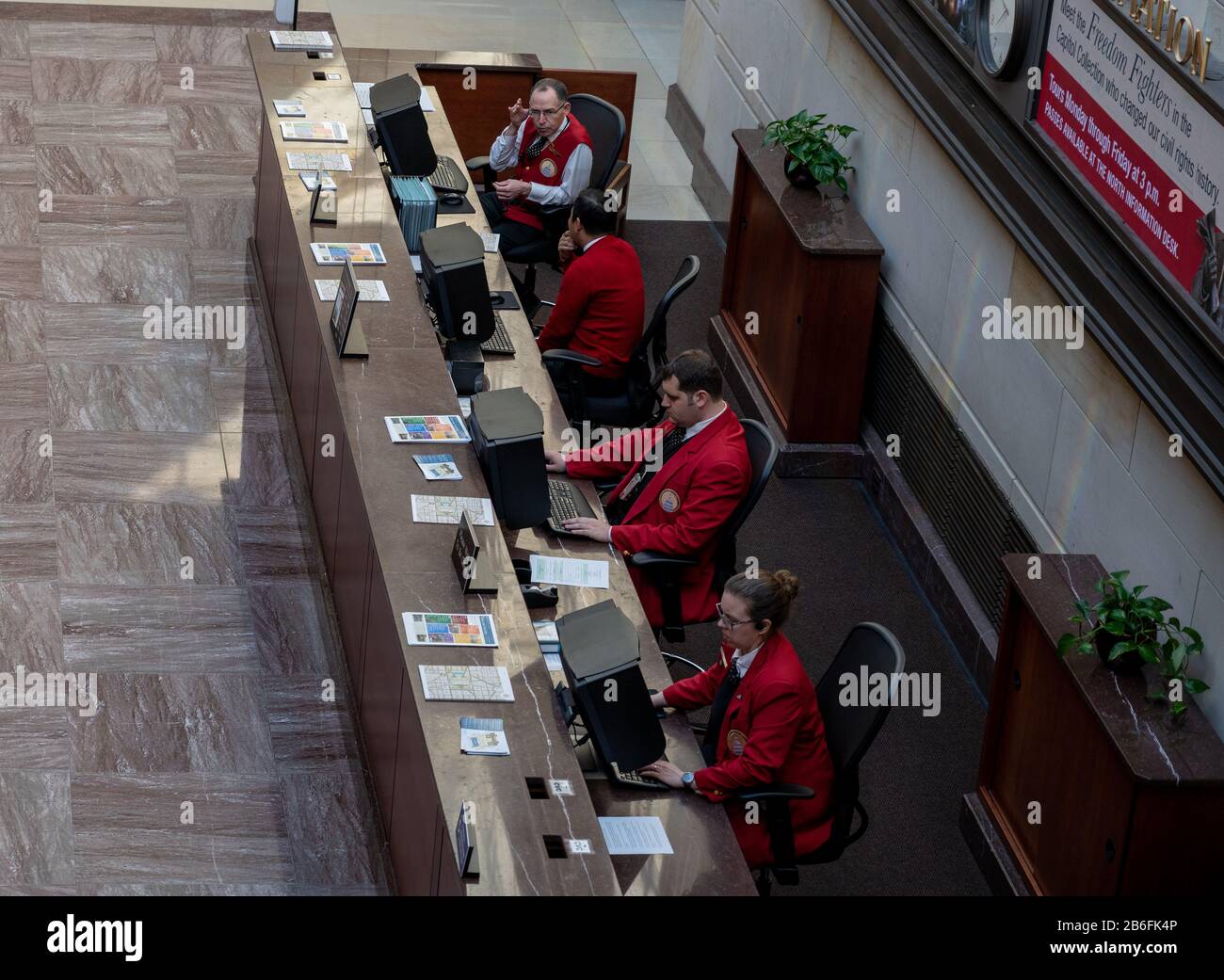 Washington, DC, USA — March 4, 2020. Clerks in red jackets working at ...