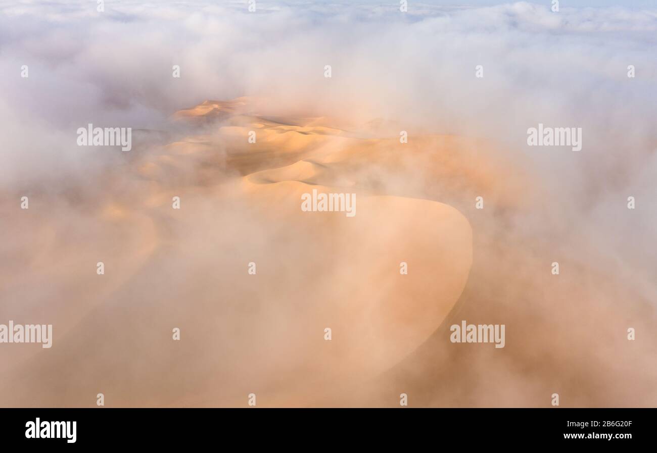 Dense fog covering desert landscape early winter morning. Liwa desert ...