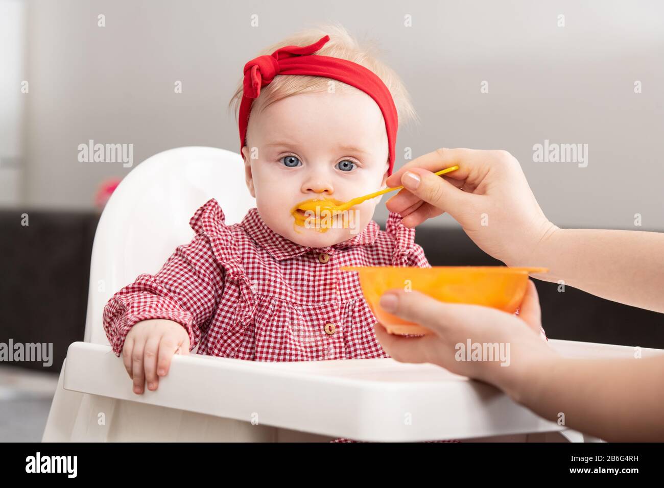 Mother Feeding Her Baby Daughter With Spoon - Mother Giving Healthy ...