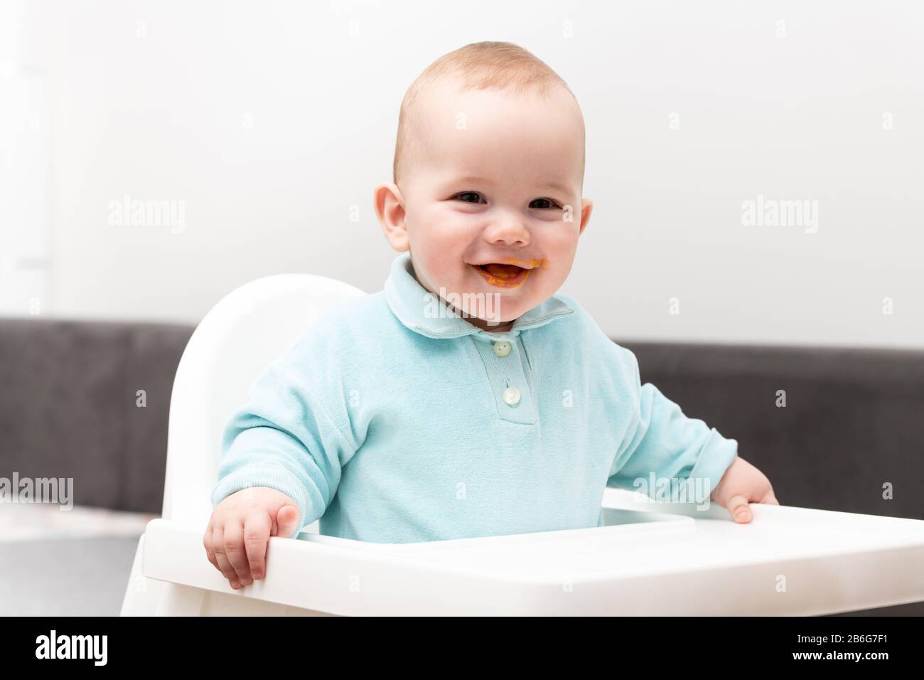 Portrait Of Cute Adorable Caucasian Child Kid Boy Sitting In High Chair ...
