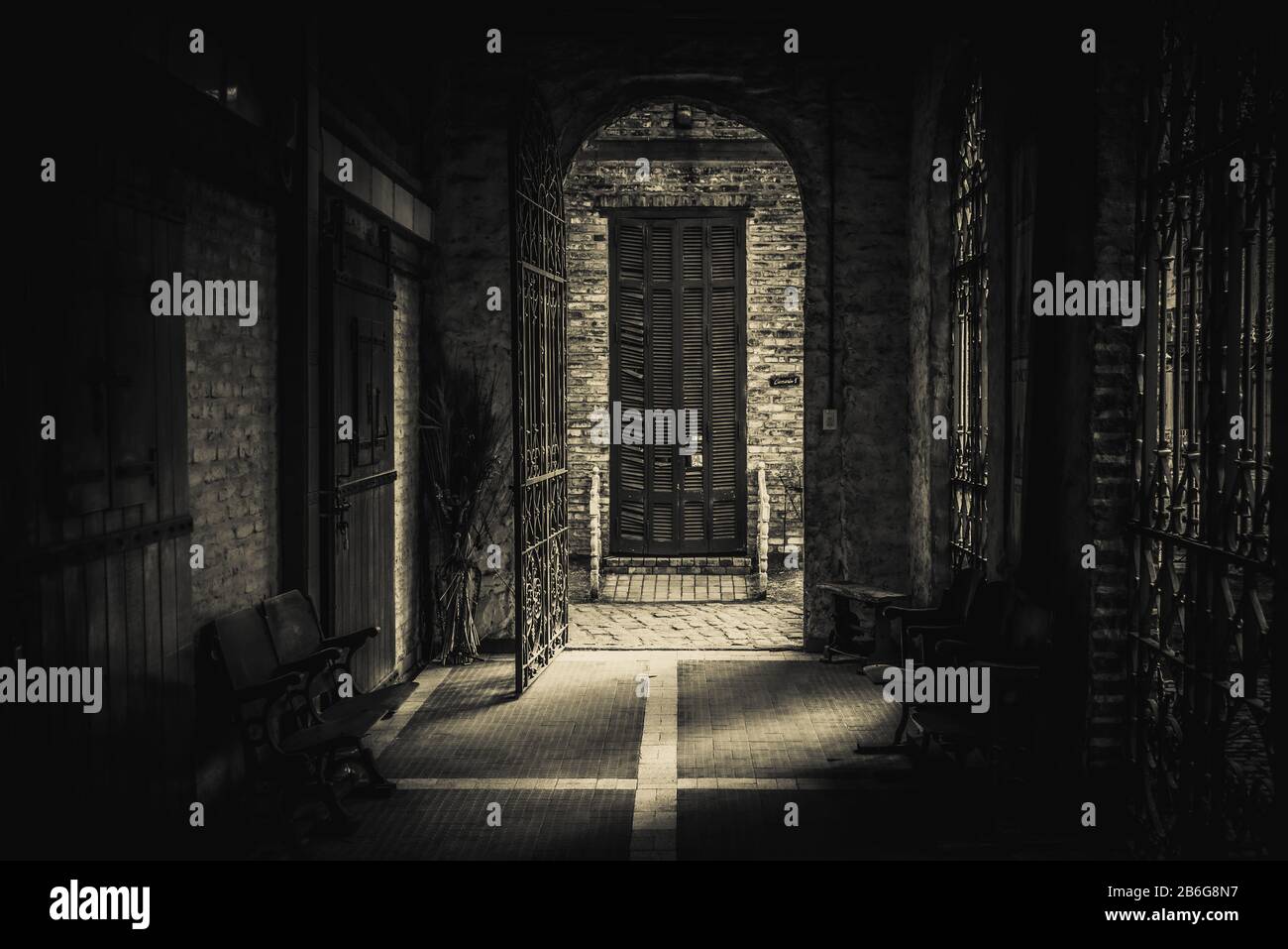 Drawing-like view of scary passage leading to an old brick arch with a ...