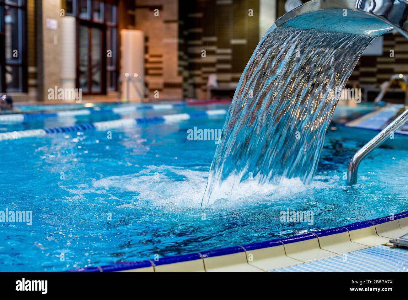 A turquoise waterfall, back and shoulder massage in the pool. relaxing ...
