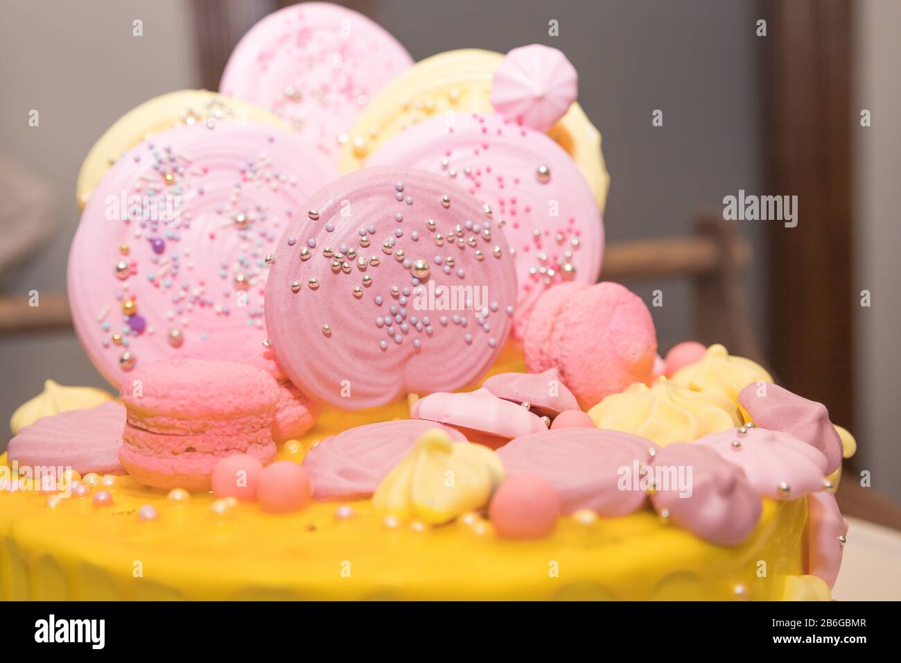 Candy bar. A big yellow pink cake with round gingerbread, marshmallows ...