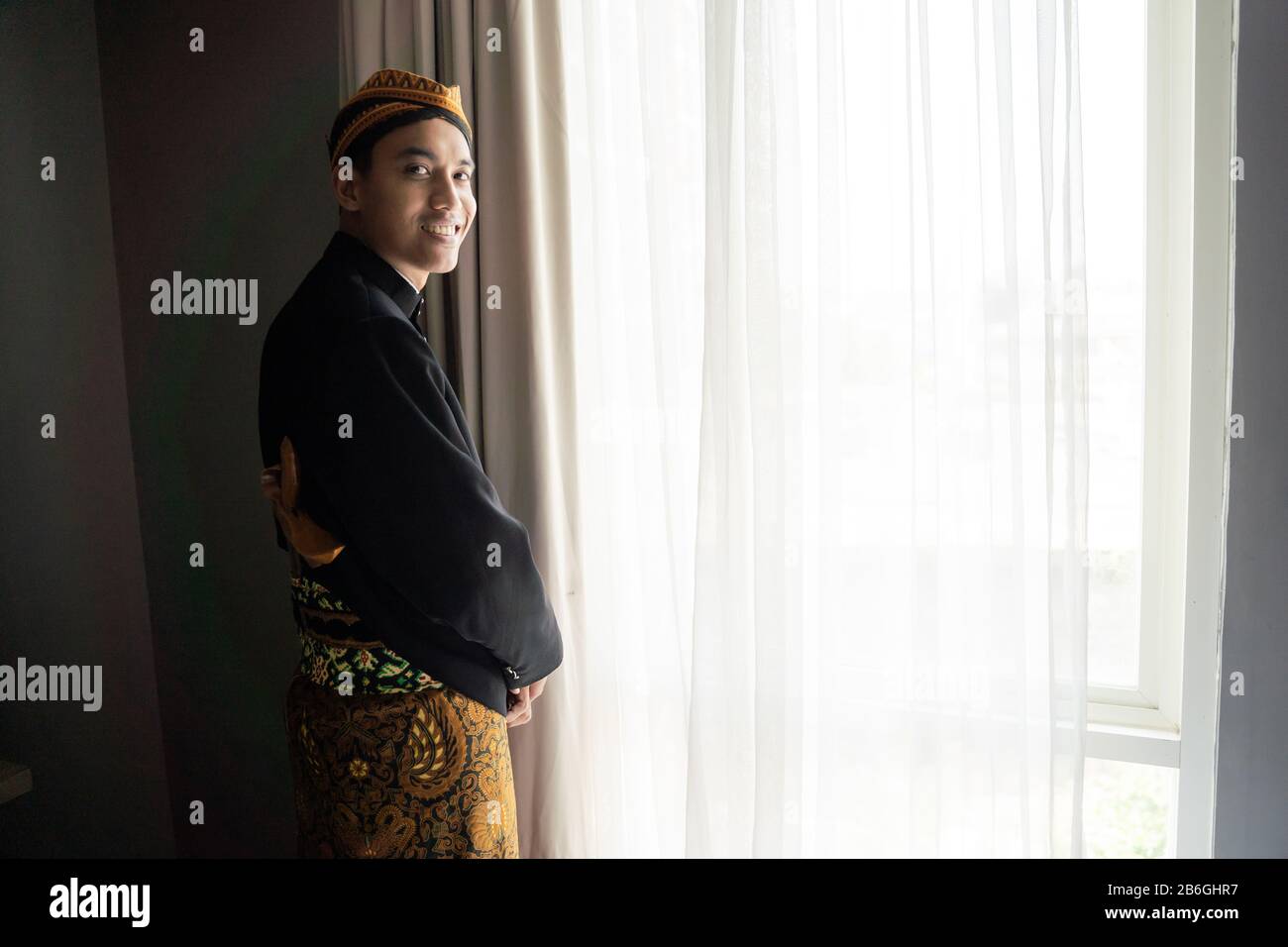 Young asian man wearing traditional clothes,beskap is traditional ...