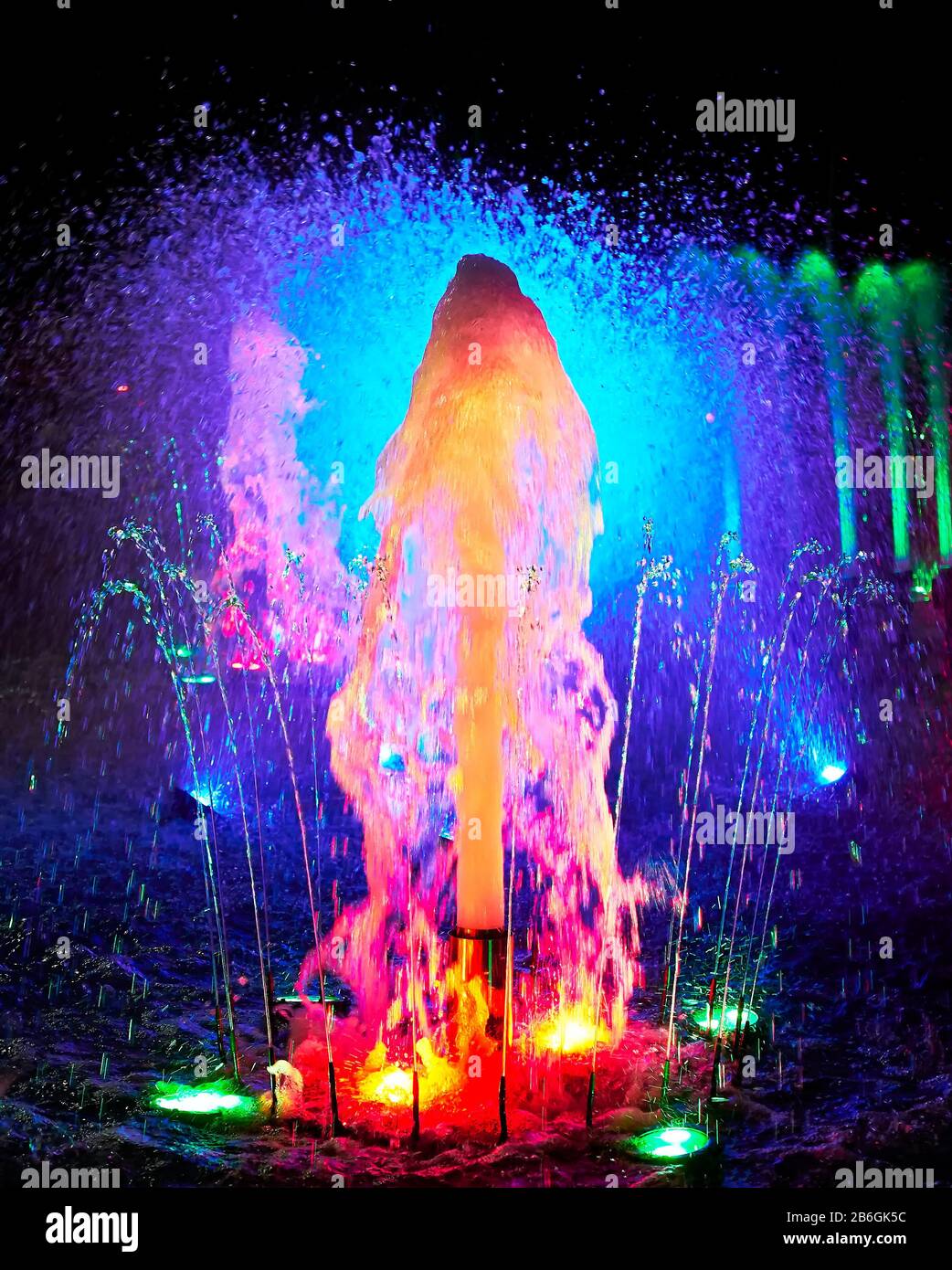 Close-up of a beautiful colorful illuminated water fountain attraction ...