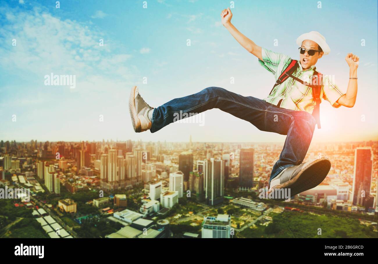 traveller man jumping floating over modern city skyscraper Stock Photo ...