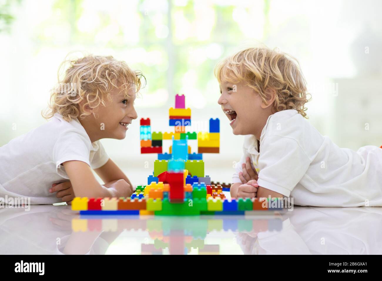Child playing with colorful toy blocks. Kids play with plastic bricks ...