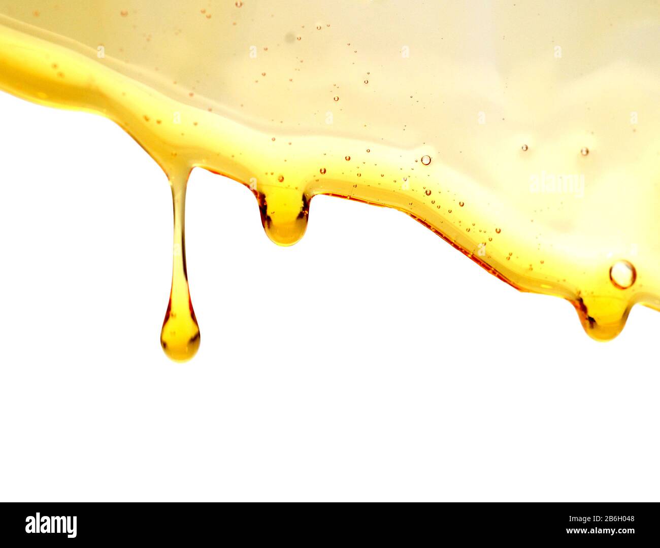 Flow and drop of honey Stock Photo - Alamy