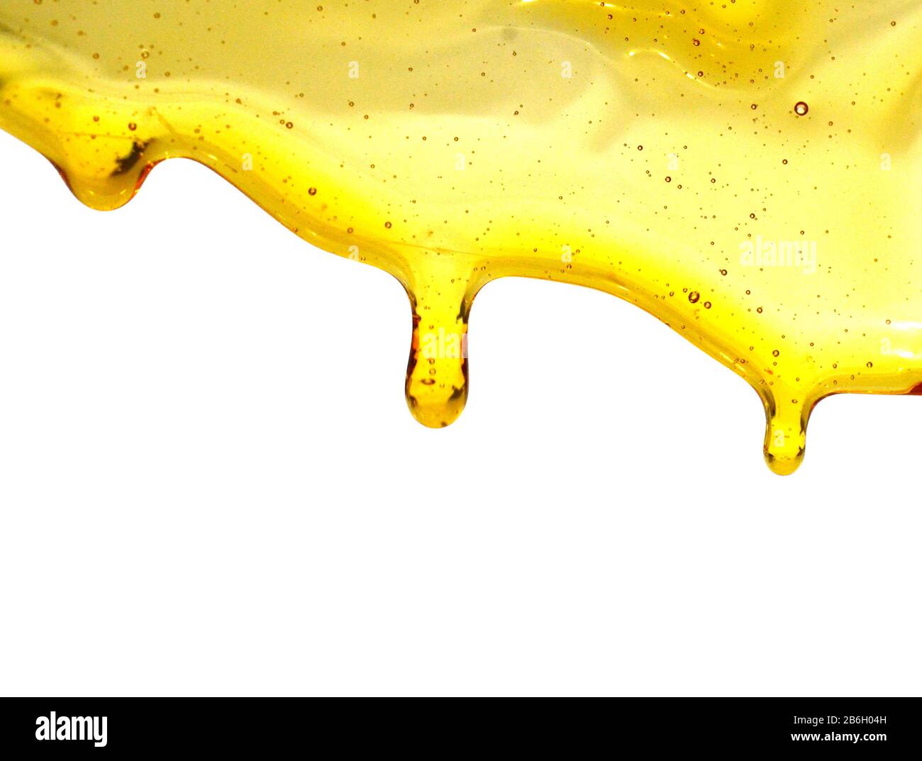 Flow and drop of honey Stock Photo - Alamy