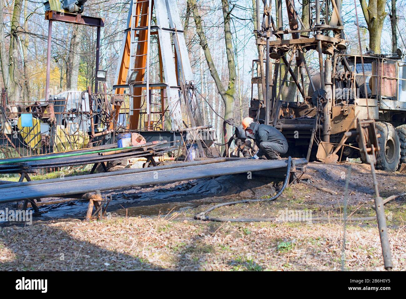 Workover rig working on a previously drilled well trying to restore ...