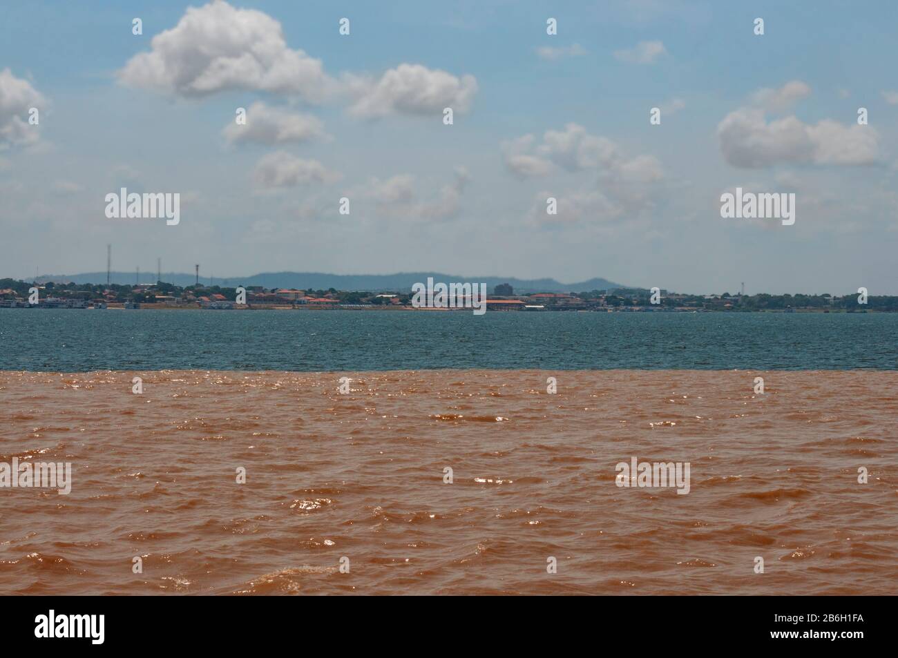 Meeting of the waters of the Rio Negro and Rio Solimoes Rivers in front ...