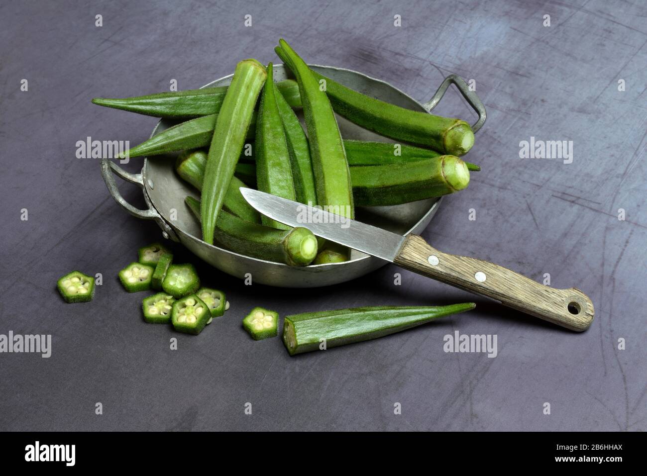 Okras in bowl and kitchen knife, Germany Stock Photo - Alamy