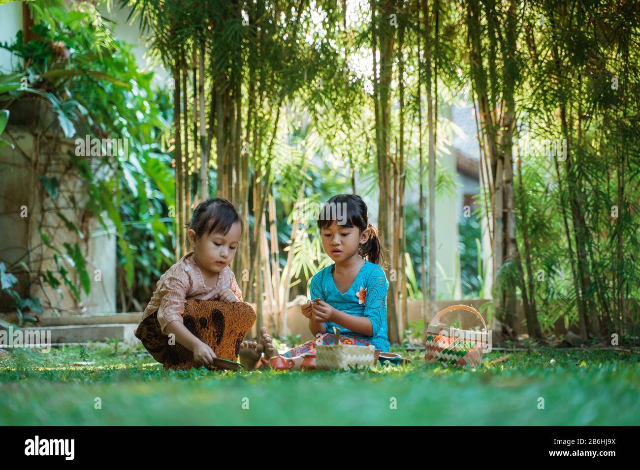 Two pretty girl wearing traditional javanese kebaya playing on the ...