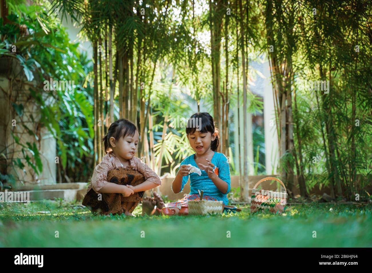 Two pretty girl wearing traditional javanese kebaya playing on the ...