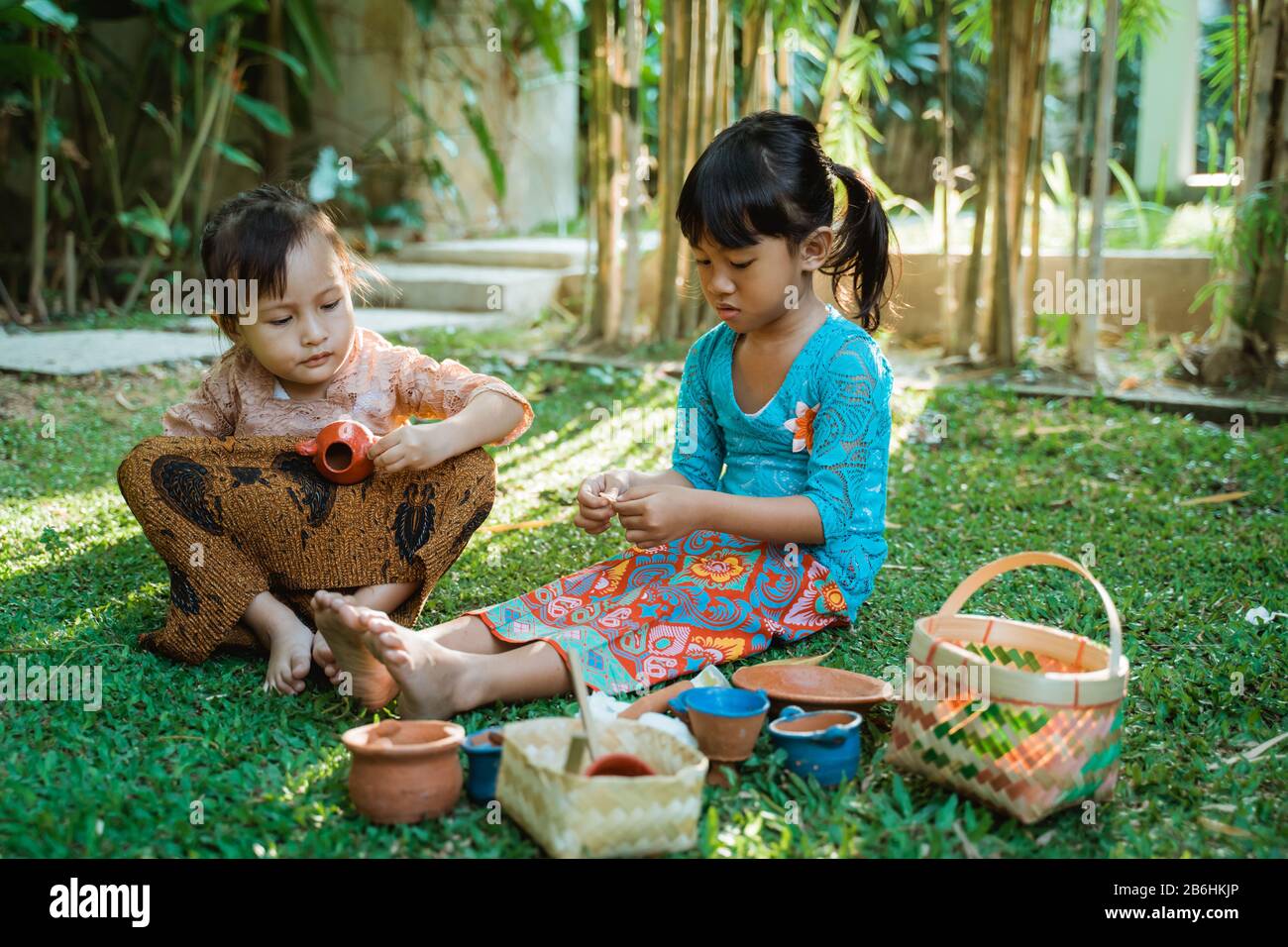 happiness two pretty girl wearing traditional javanese kebaya playing ...