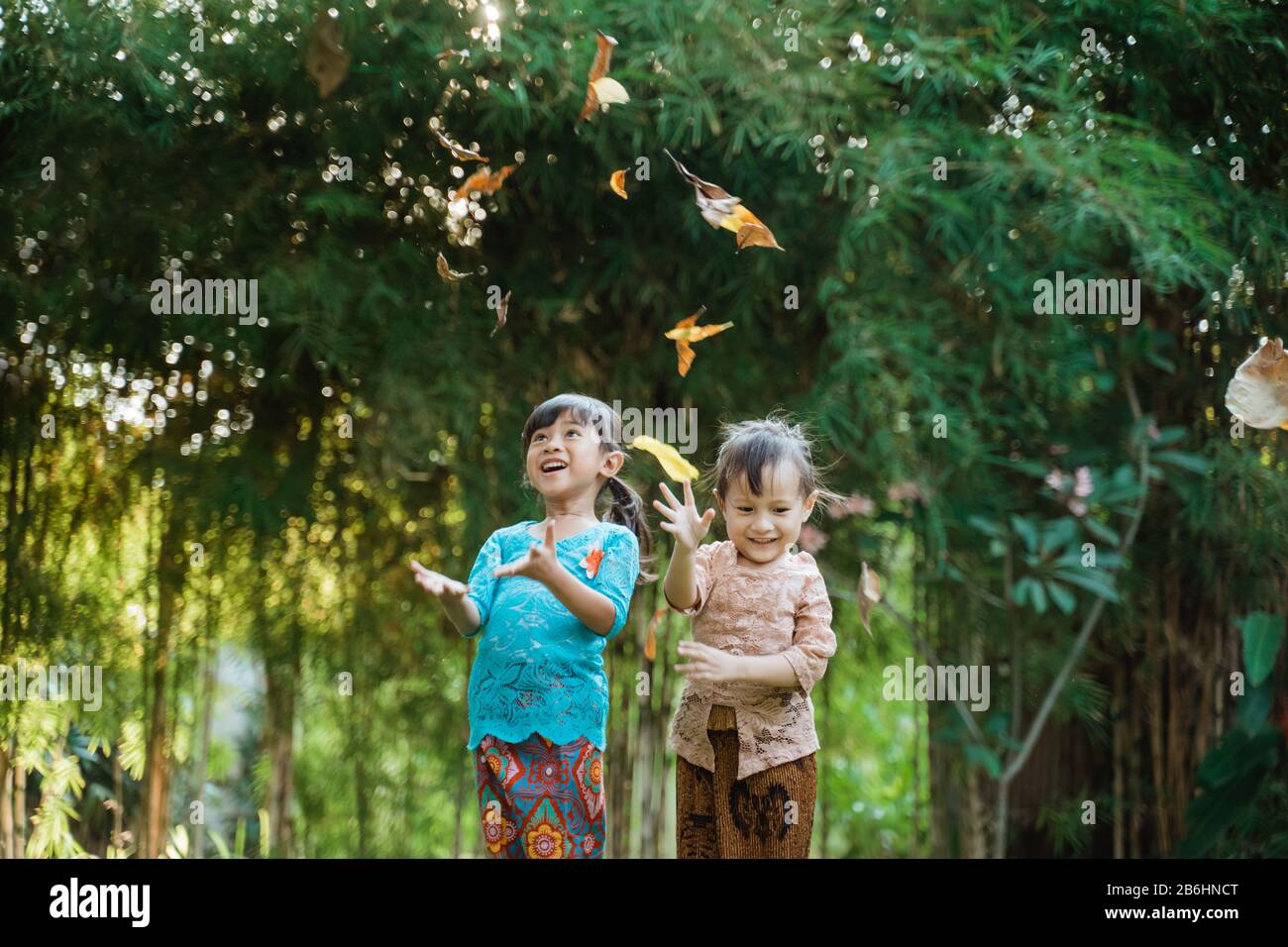 happiness two pretty girl wearing traditional javanese kebaya playing ...
