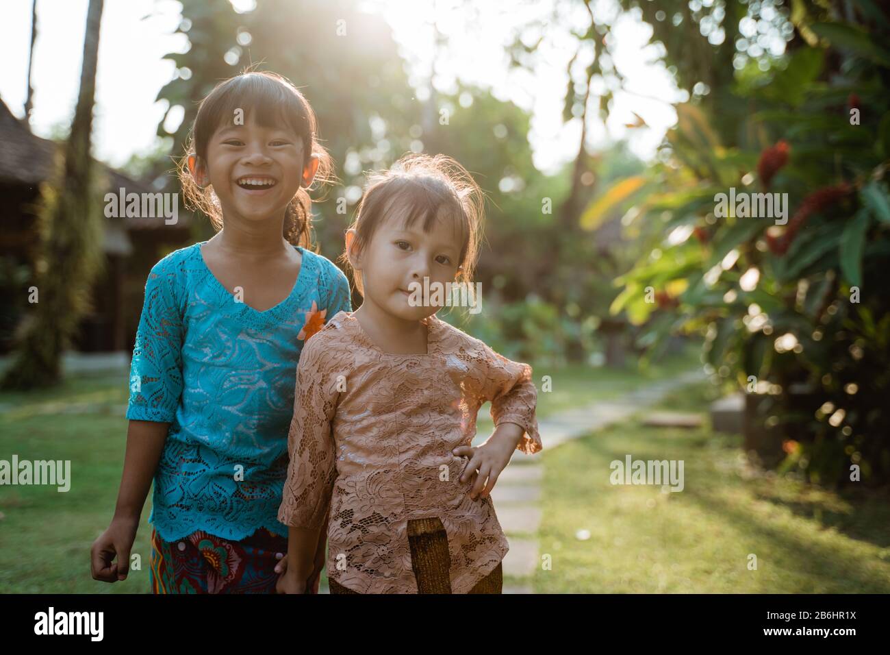 Two pretty girl wearing traditional javanese kebaya with holding hands ...