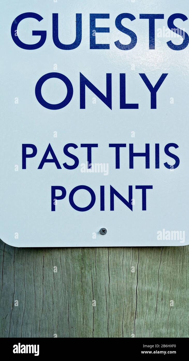 Guests Only Past This Point sign on post warning not to enter private ...