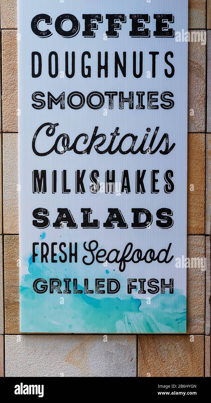 Cafe food and drink menu sign on a brick wall Stock Photo - Alamy
