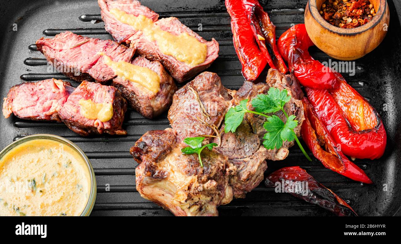 Grilled steak with spices and herbs on grill iron pan Stock Photo - Alamy