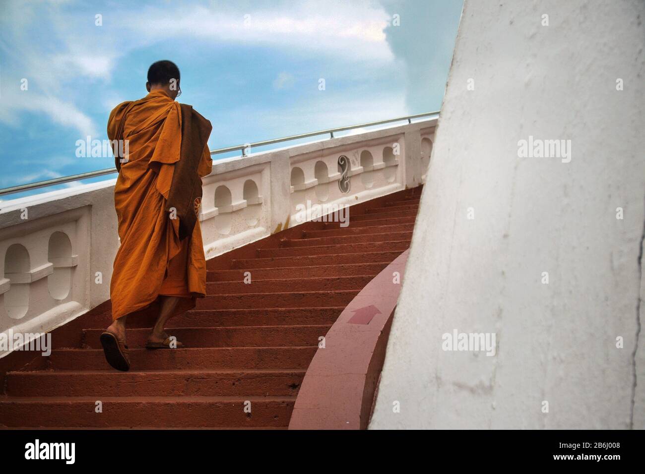 Monks climbing stairs in buddhist temple Stock Photo - Alamy