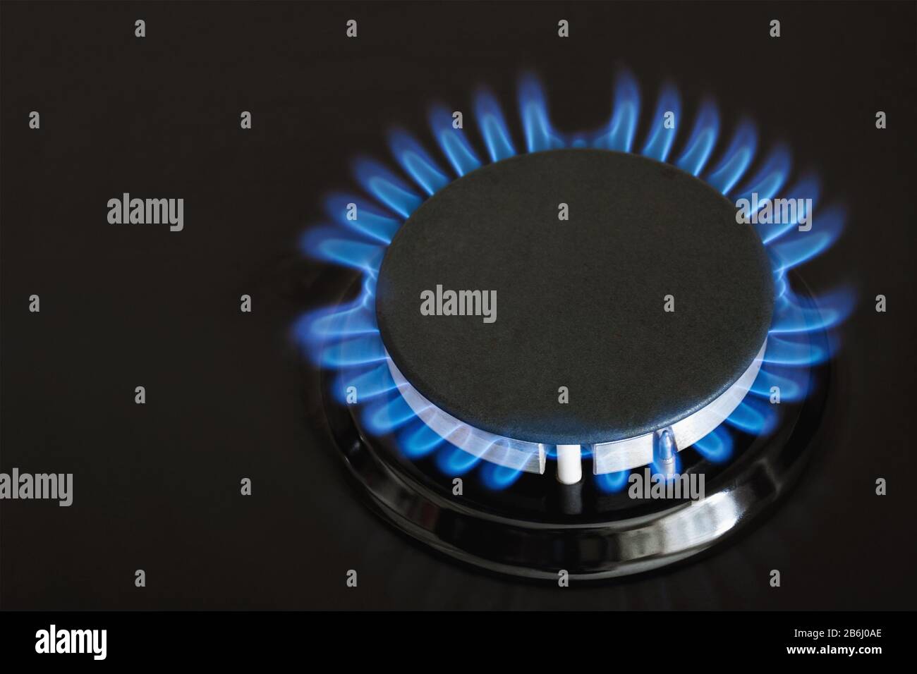 Burning blue gas on the dark stove. Burner gas stove, concept of energy ...
