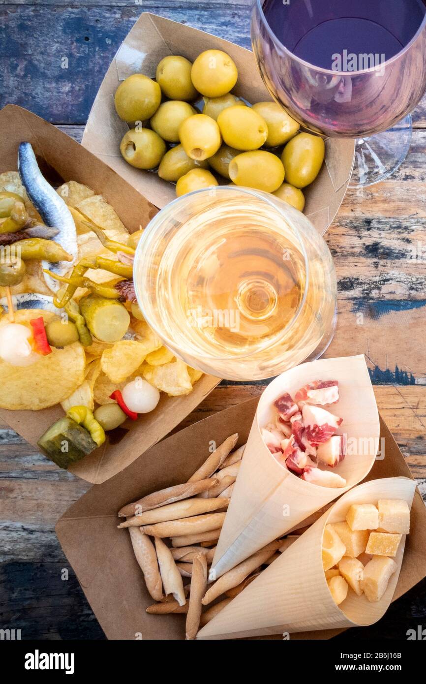 Tapas, pinchos, and wine. Cheese, jamon and olives, spicy gildas and ...