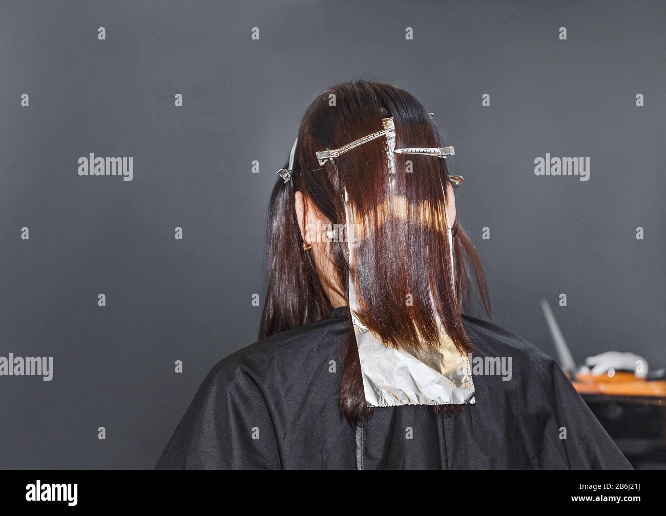 Professional hairdresser colorist dyeing hair of her client at beauty ...