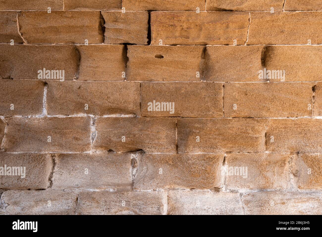 Ancient sandstone stone wall background Stock Photo - Alamy