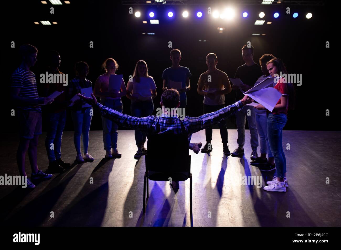 Rear view of teacher in front of students in a theater Stock Photo - Alamy