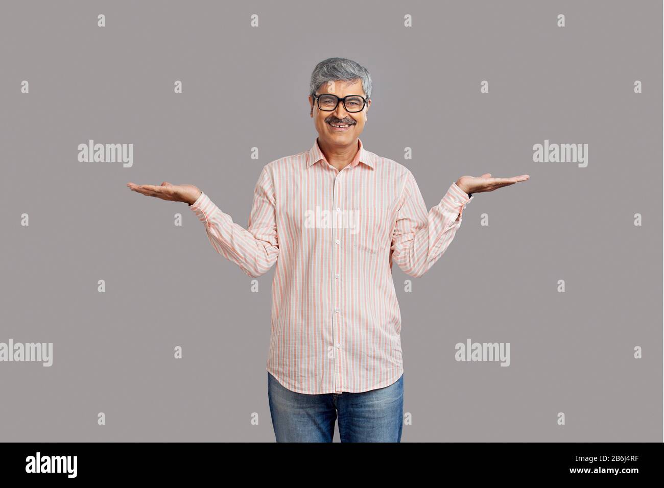 Senior man standing and showing his empty palms Stock Photo - Alamy