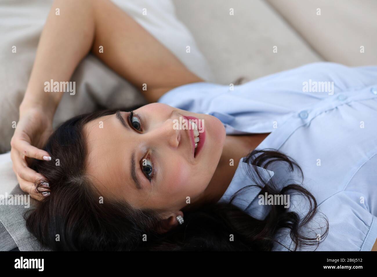 Good-looking lady relax on couch Stock Photo - Alamy