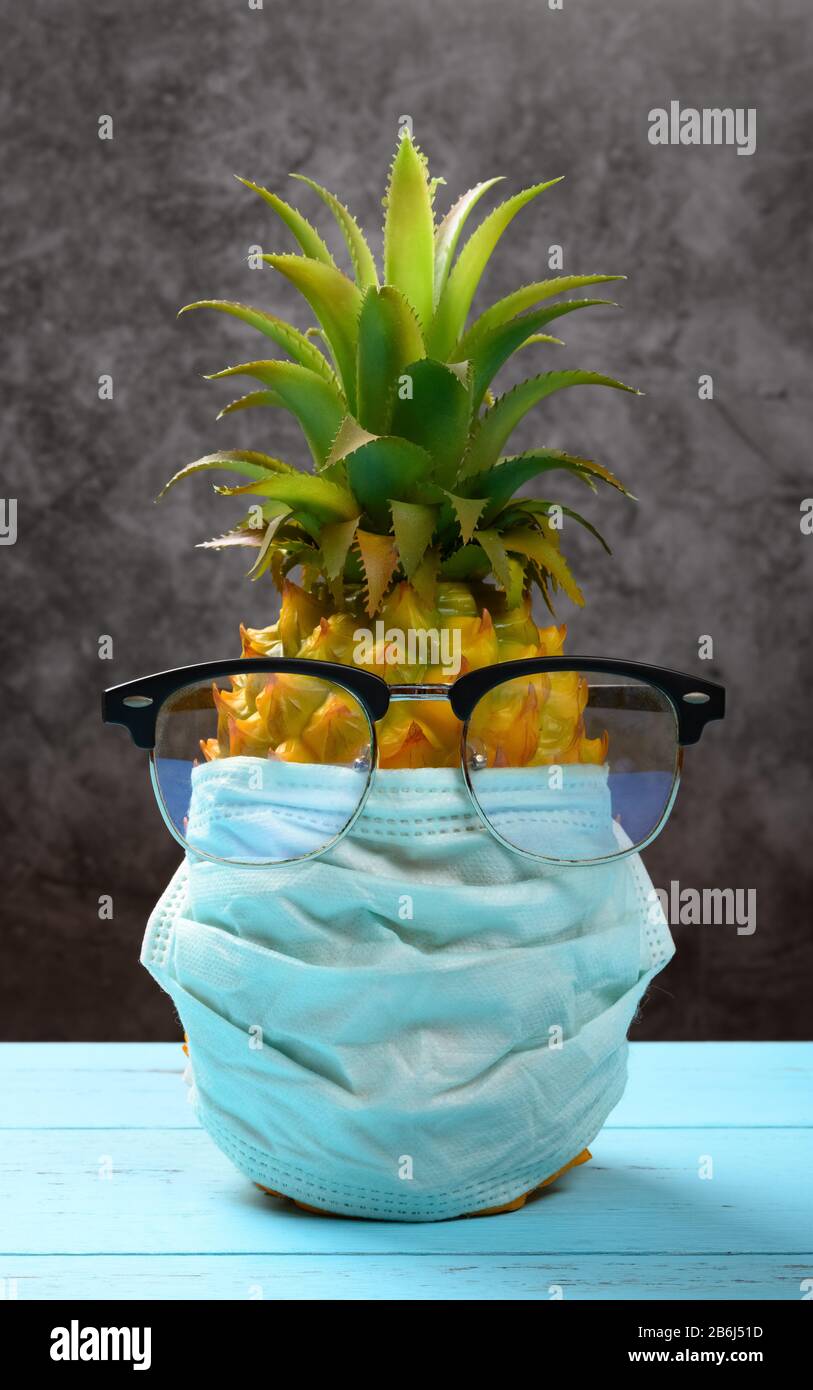 Pineapple wears face mask concept hi-res stock photography and images ...