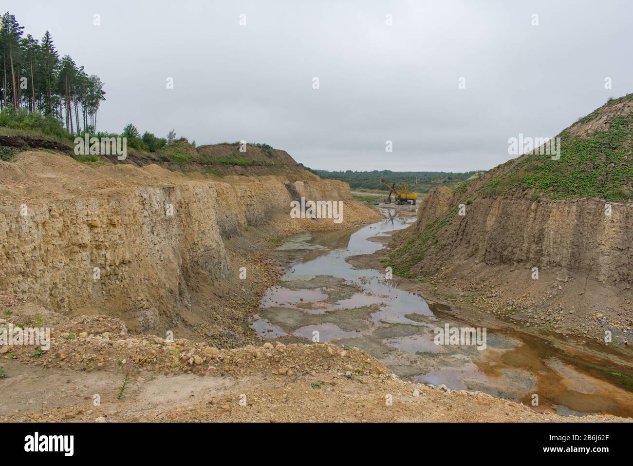 Landscape view of limestone quarry with high cliffs and canyons, and ...