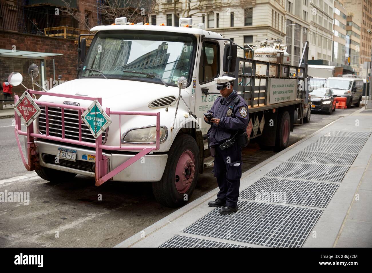New York city lower Manhattan NYPD traffic officer writing a parking ...