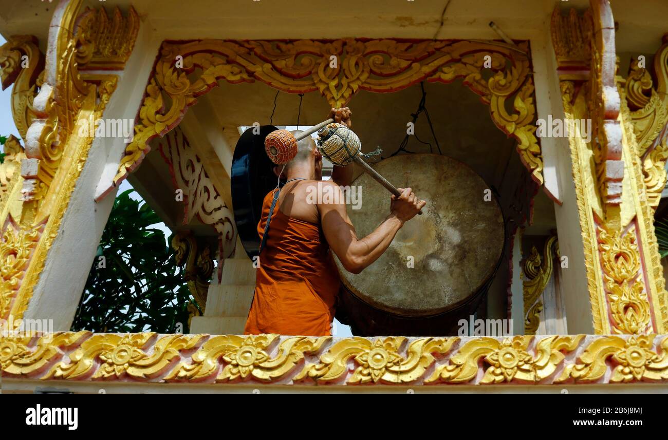 monk play music with hammer on drum Stock Photo - Alamy