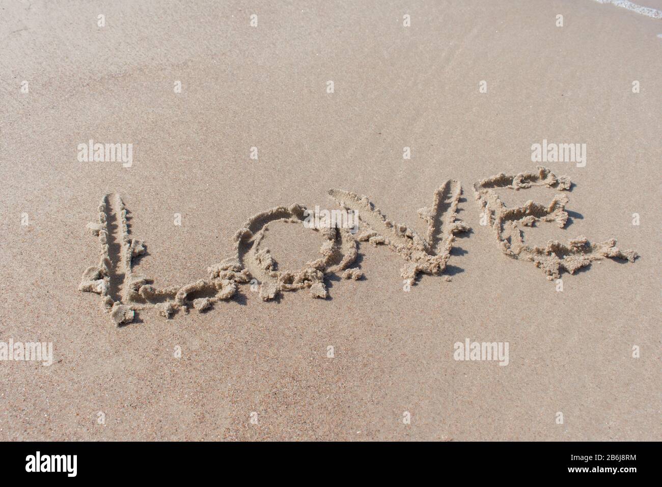 Love written in the sand hi-res stock photography and images - Alamy