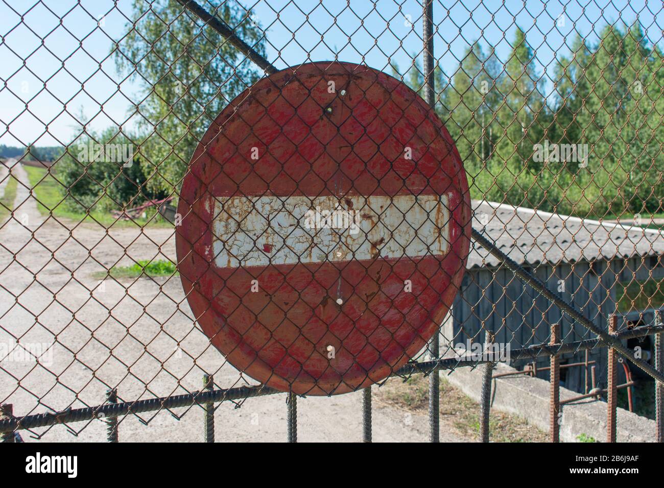 Old no entry for vehicular traffic road sign on rusty fence. Forbidden ...
