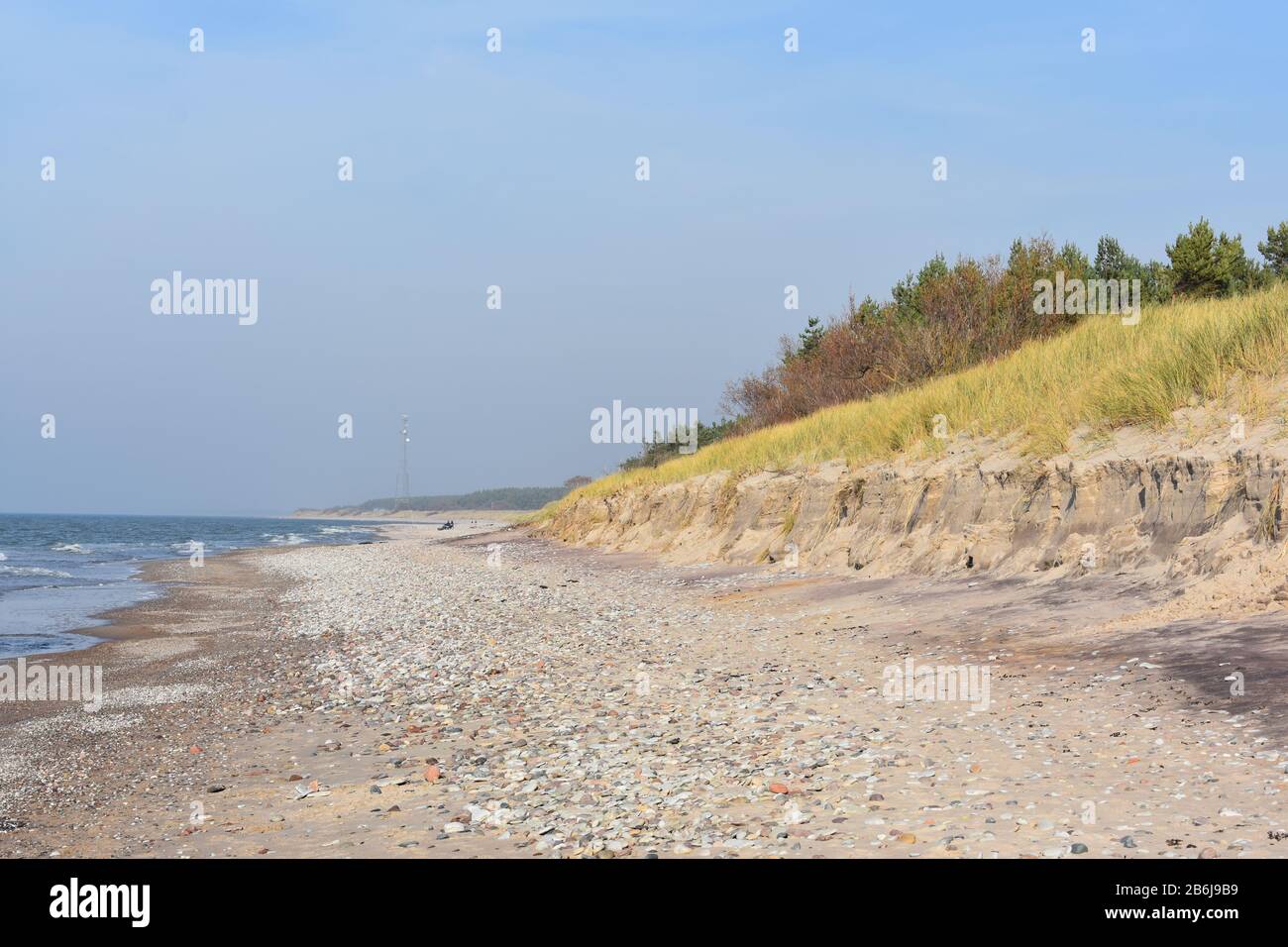Beach landscape with steep dune coast blue sky Liepaja Skede Latvia ...