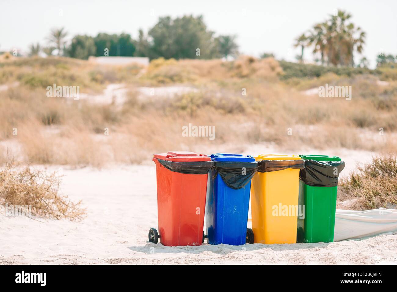 Four plastic containers for garbage sorting on the beach Stock Photo ...