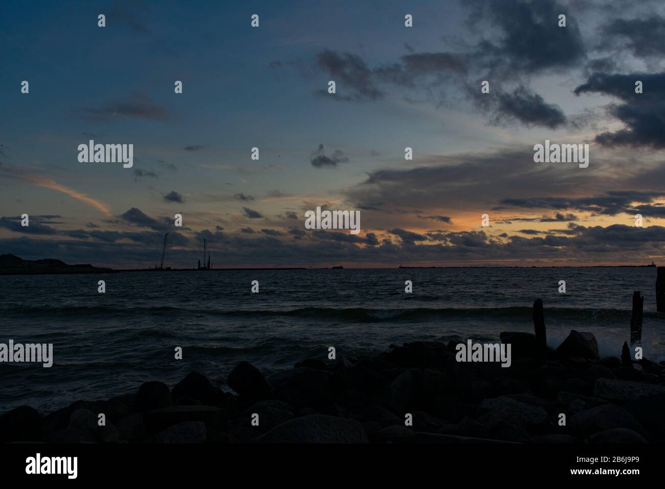 Beautiful orange sunset sky reflection on calm sea Stock Photo - Alamy