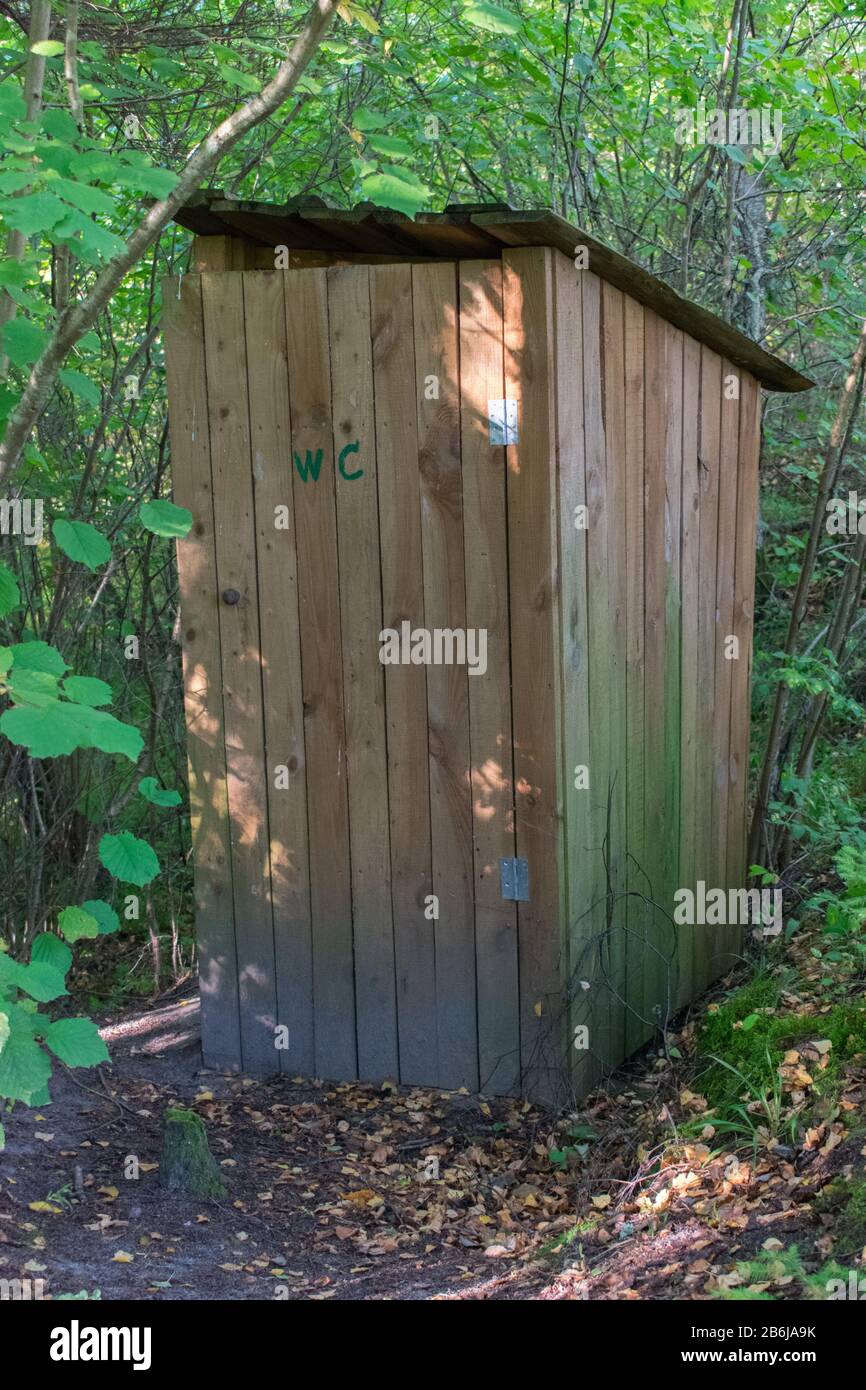 Wooden dry ecological toilet in green forest Stock Photo - Alamy