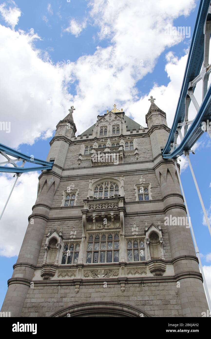Top part of Tower Bridge with the blue sky and clouds on a bright sunny ...